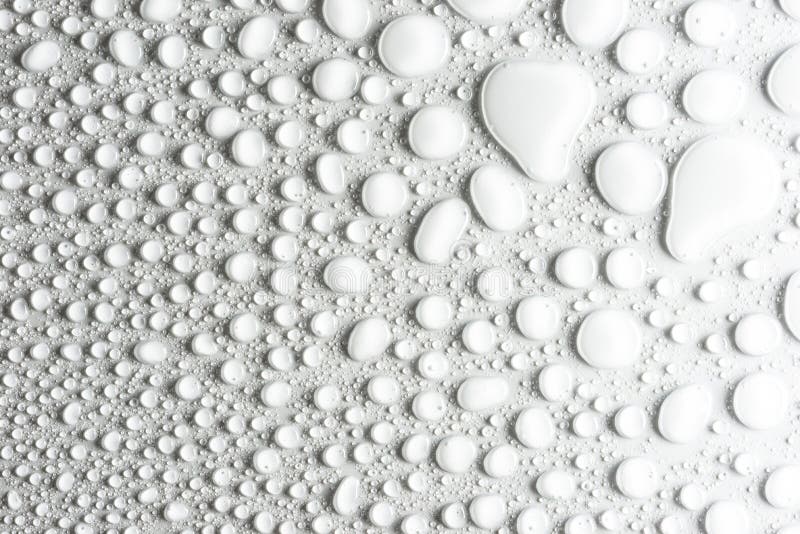 Droplets of Water on a White, Matte Background Illuminated with a ...