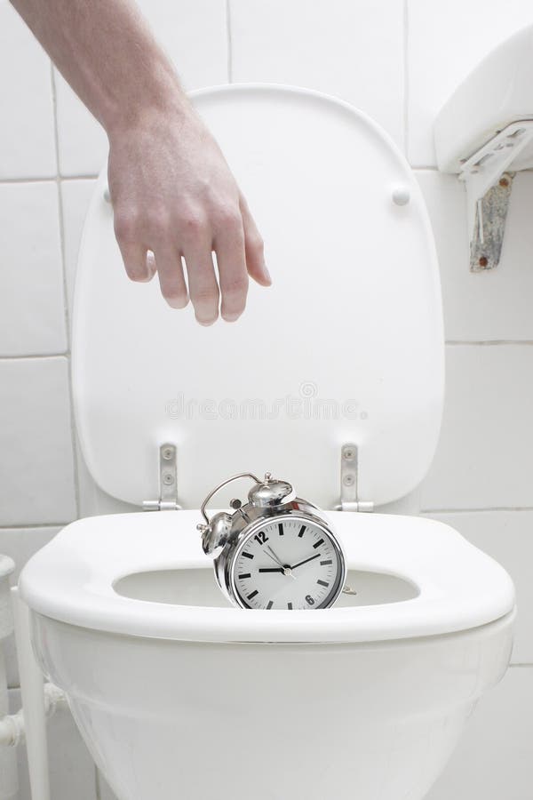Dropping a clock in toilet stock photo. Image of timer - 9457034