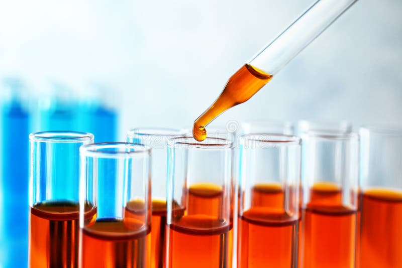 Dropping Sample into Test Tube with Orange Liquid Stock Image - Image ...