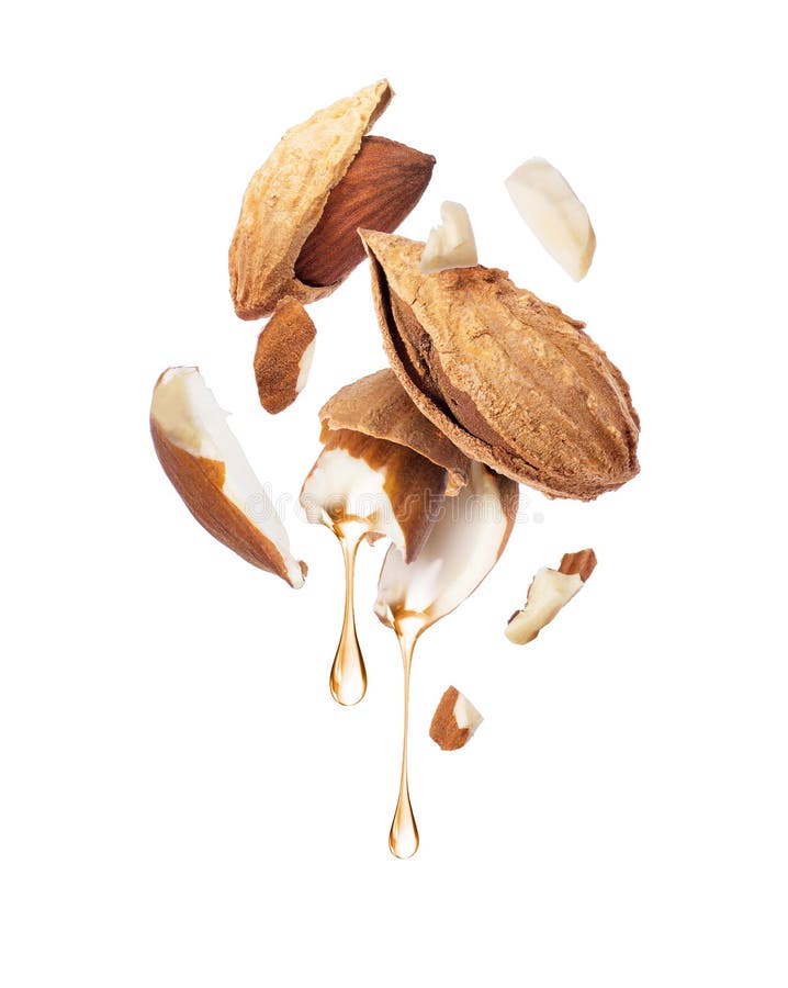 Drops of Oil Dripping from Almond Close-up on a White Background Stock ...