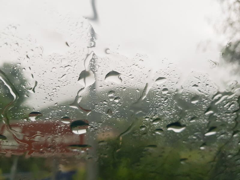 Drops Of Rain Drizzle On The Glass Windshield In The Evening. Street In ...