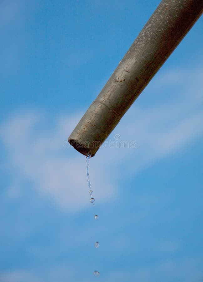 Drops of Water Flowing from Pipe - Close Up with Blue Sky. Concept for ...