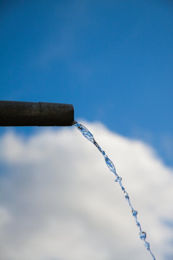 Drops of Water Flowing from Pipe - Close Up with Blue Sky. Concept for ...