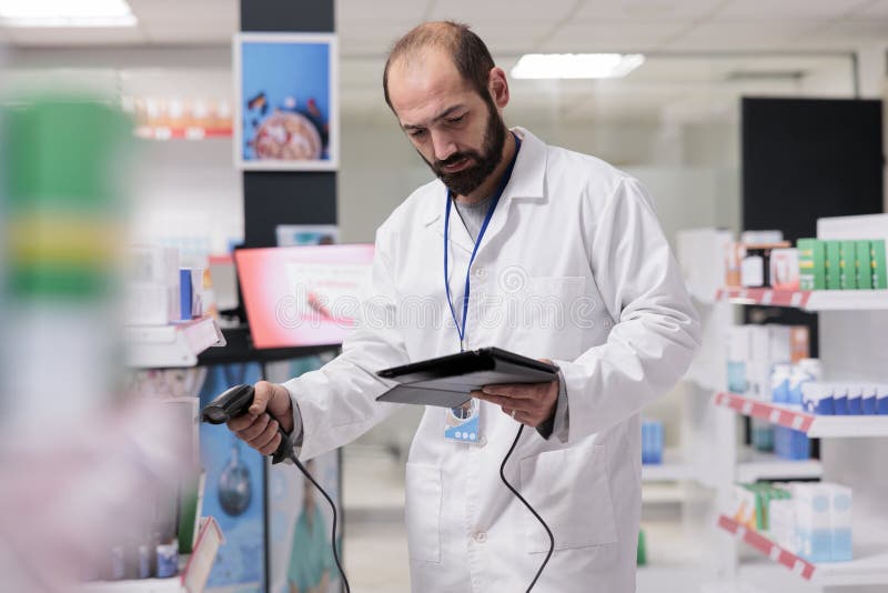 Drugstore Worker Checking Medication Information on Tablet Computer ...