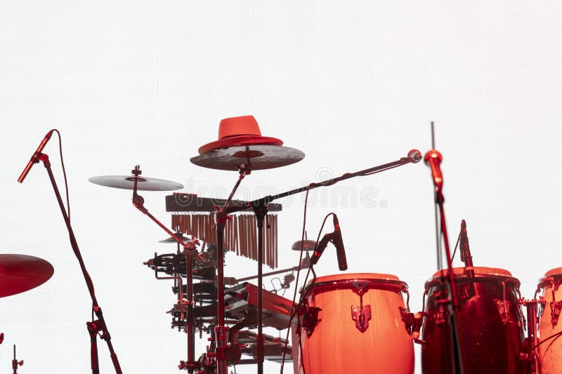 Drum Kit on Stage with Hat on Cymbal in Red Lighting on White ...