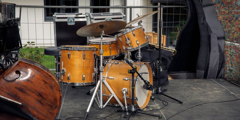 Drum Set on Outdoor Stage with Closed Double Bass Case, Musical ...