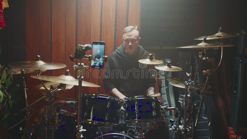 Drummer Performing in Studio Setting with Camera Recording Stock ...