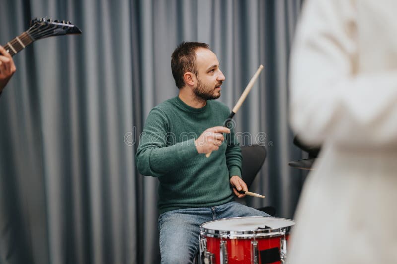 Musicians Practicing Together in a Studio Setting with Drums and ...