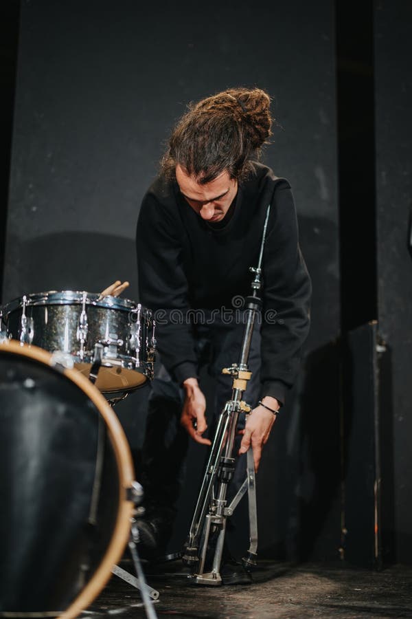 Drummer Setting Up Drum Equipment on Stage Under Stage Lights Stock ...