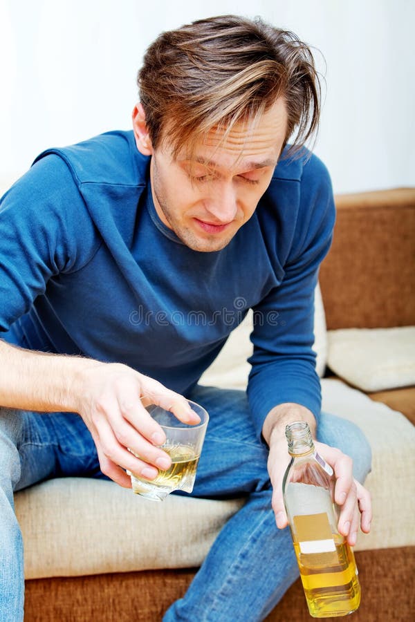 Drunk Man Sitting on Couch and Drinking Whiskey Stock Photo - Image of ...