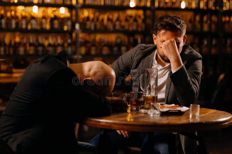 Drunken Men Sleeping on a Table in a Pub after Work. Friends ...