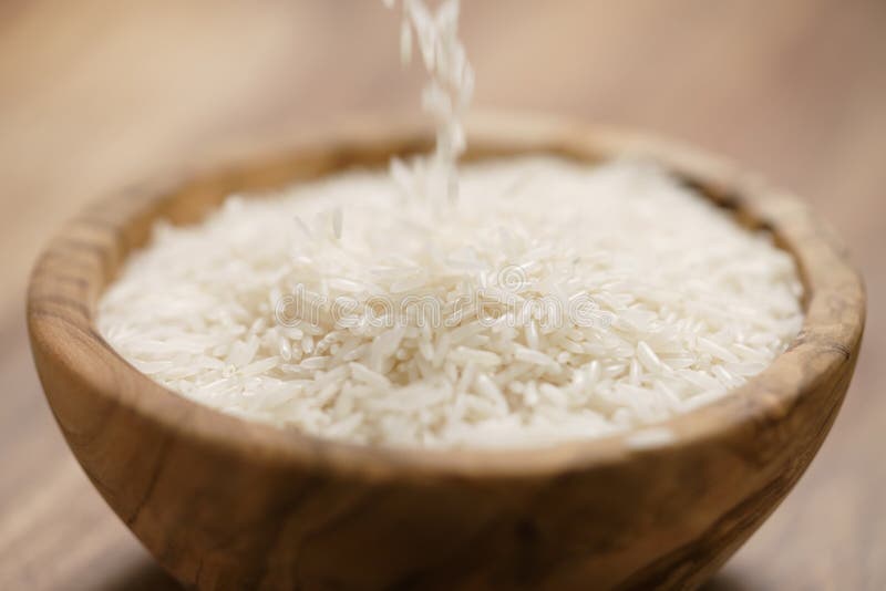 Dry Basmati Rice Fall in Wood Bowl on Table Stock Photo - Image of ...