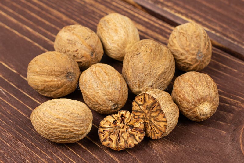 Dry Brown Nutmeg Isolated on Black Glass Stock Photo - Image of ...