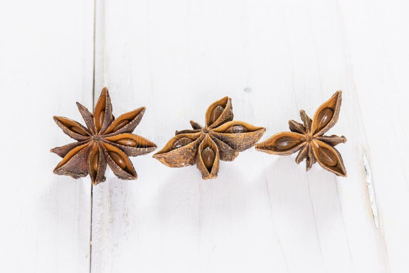 Dry brown star anise fruit on grey wood, Group of three whole dry brown ...