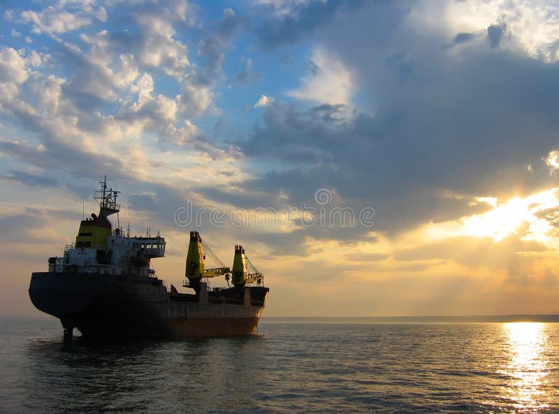 Dry Cargo Ship at Sunset stock photo. Image of passage - 11312134