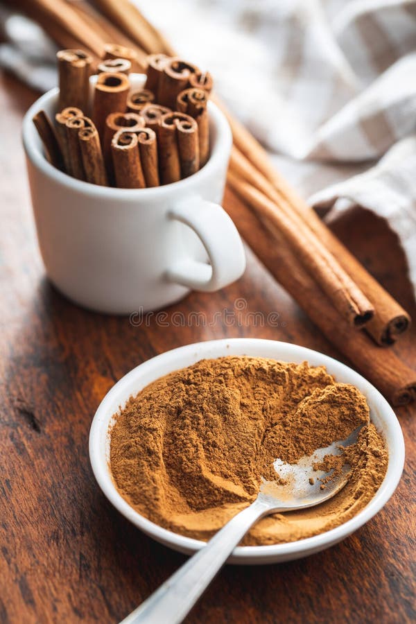 Dry Cinnamon Sticks and Cinnamon Powder on Wooden Table. Cinnamon Spice ...