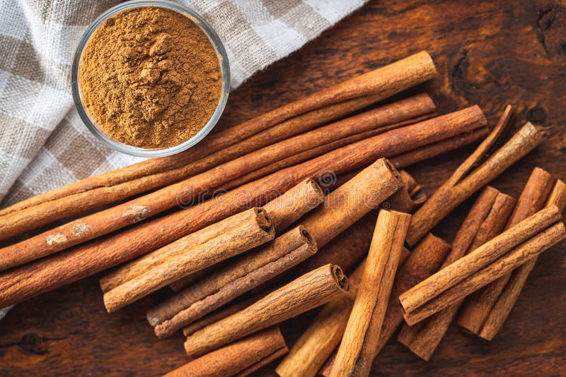 Dry Cinnamon Sticks and Cinnamon Powder on Wooden Table. Cinnamon Spice ...