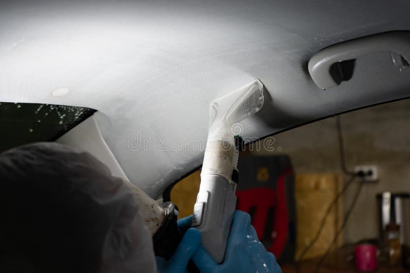 Dry Cleaning of the Car. Worker Disinfects with a Vacuum Cleaner in a ...