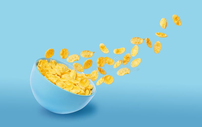 Dry Corn Flakes in a Blue Ceramic Plate, Some of the Corn Flakes are ...