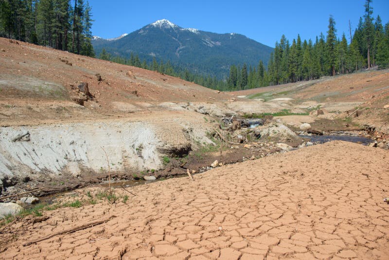 Dry Cracked Bed of the River during Drought, Mountain in Distance Stock ...
