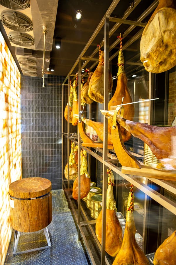 Dry-cured Pork Ham, Jamon, Hanging on Hooks in the Refrigerator Stock ...