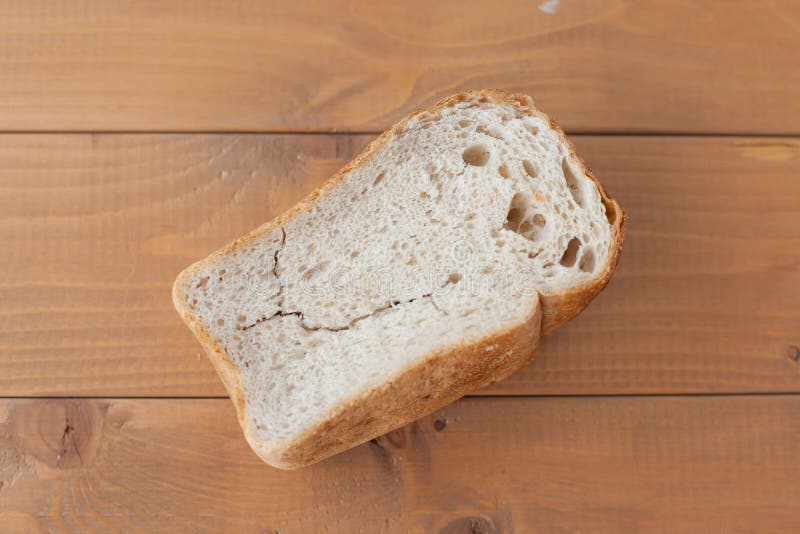 A Dry Loaf of Bread on a Wooden Table. Old Food Stock Photo - Image of ...