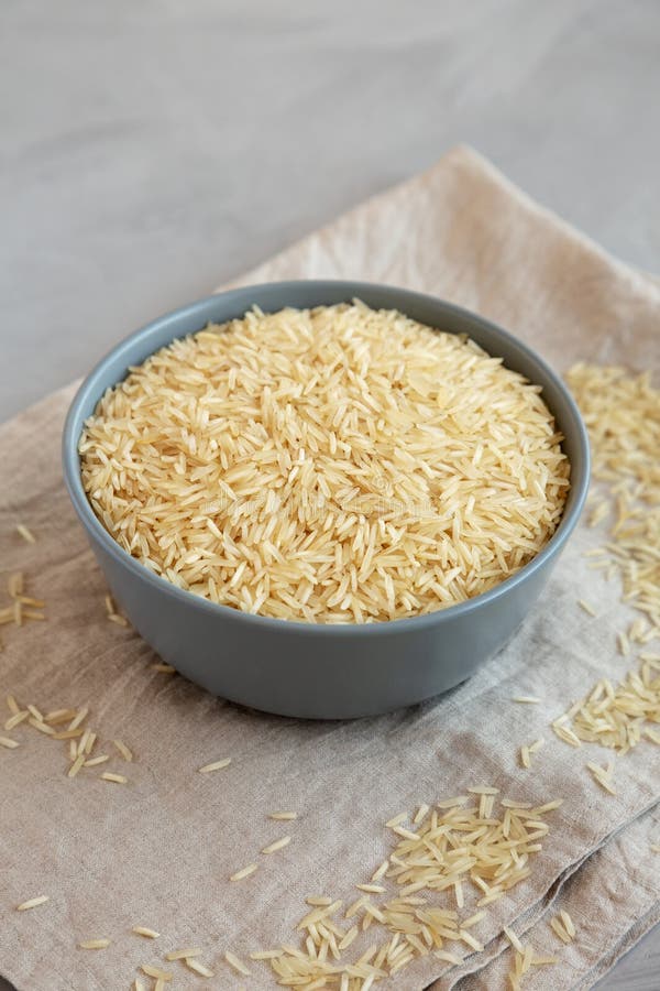 Dry Organic Basmati Rice in a Bowl on a Gray Background, Side View ...