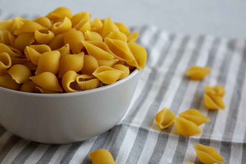 Dry Organic Medium Pasta Shells in a Bowl, Side View Stock Photo ...