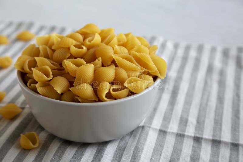 Dry Organic Medium Pasta Shells in a Bowl, Side View Stock Photo ...