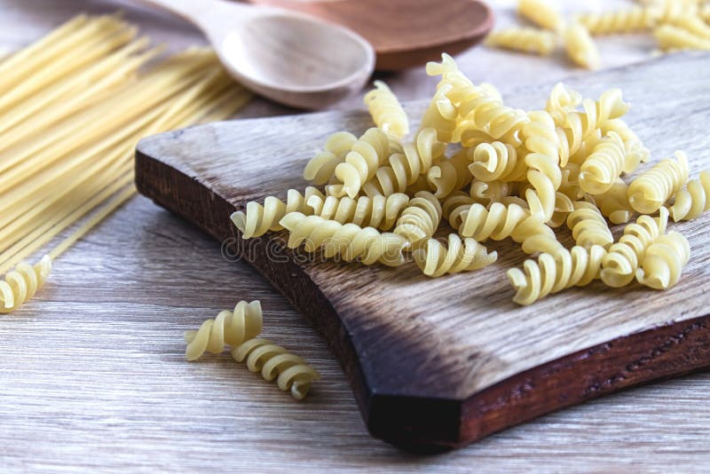 Dry Pasta on a Cutting Board on the Table Stock Photo - Image of food ...