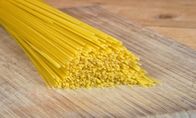 Dry Pasta on Cutting Board stock photo. Image of cutting - 204684652