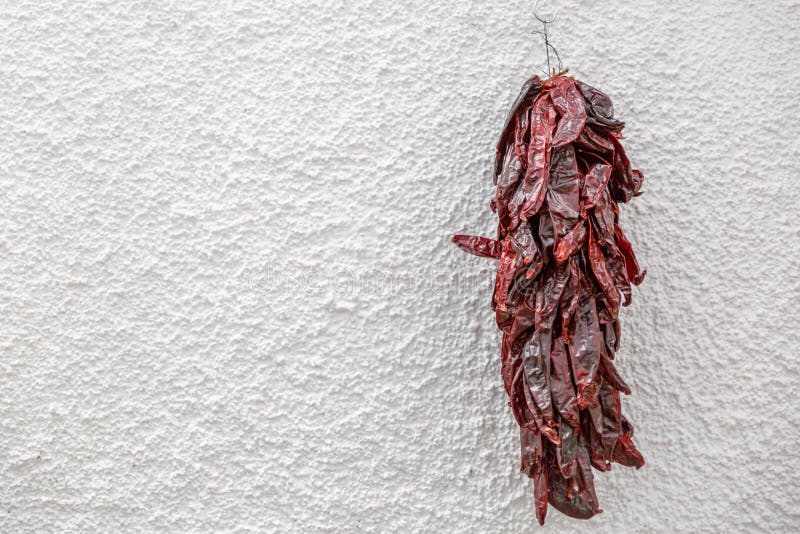 Dry Red Peppers Hanging on a White Wall Stock Photo - Image of bundle ...
