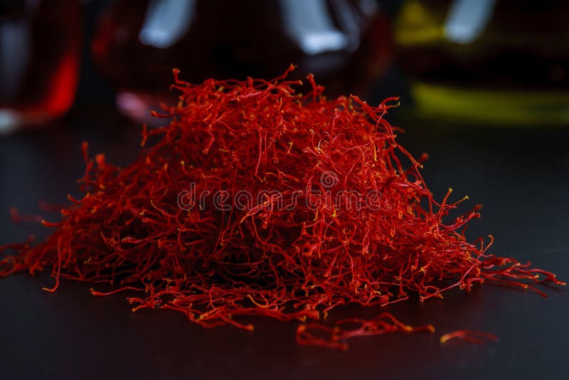 Dry Red Saffron and Oil Extract on Black Background Stock Image - Image ...