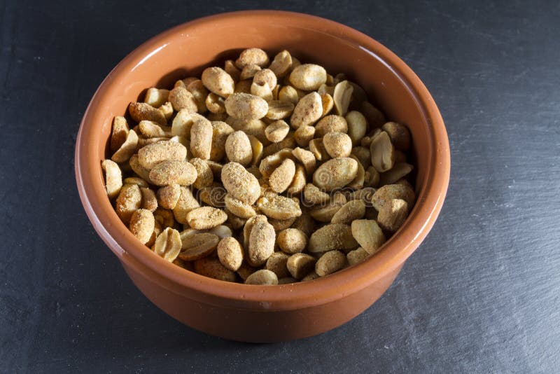 Dry Roasted Peanuts in Terracotta Ramekin on Slate. Stock Photo - Image ...