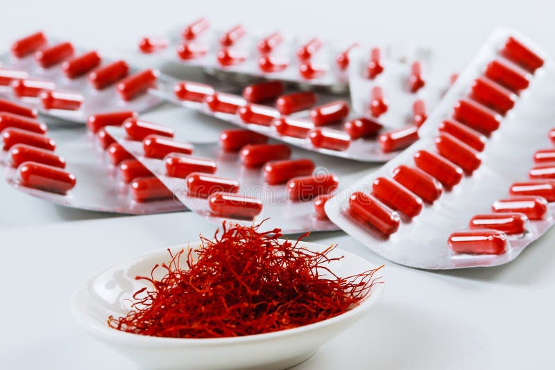 Dry Saffron Threads and Pills in Blister on a White Background Stock ...