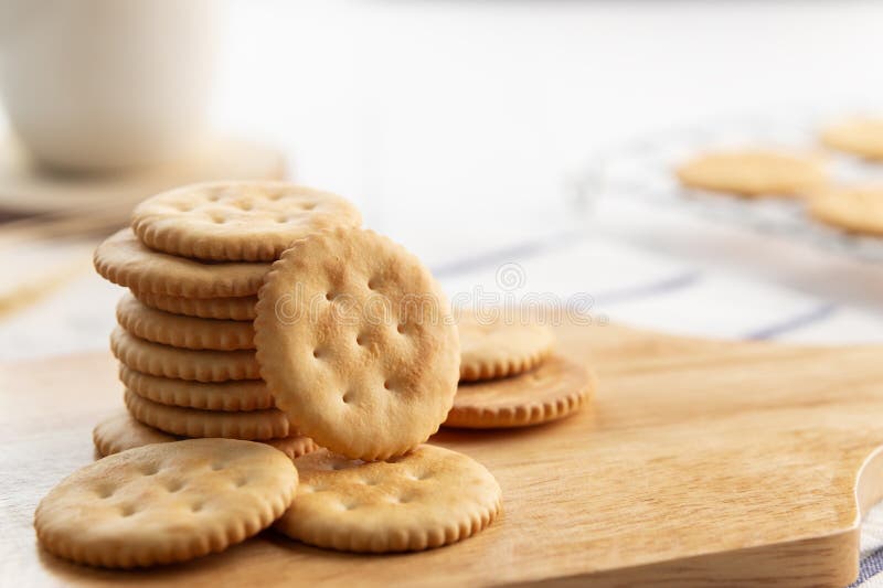 Dry Thin Circle Crispy Crackers on Cutting Board on Wood Table. Stock ...