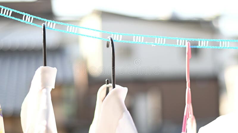 Drying Clothes in the Sun Using a Laundry Rope that Keeps Clothes ...