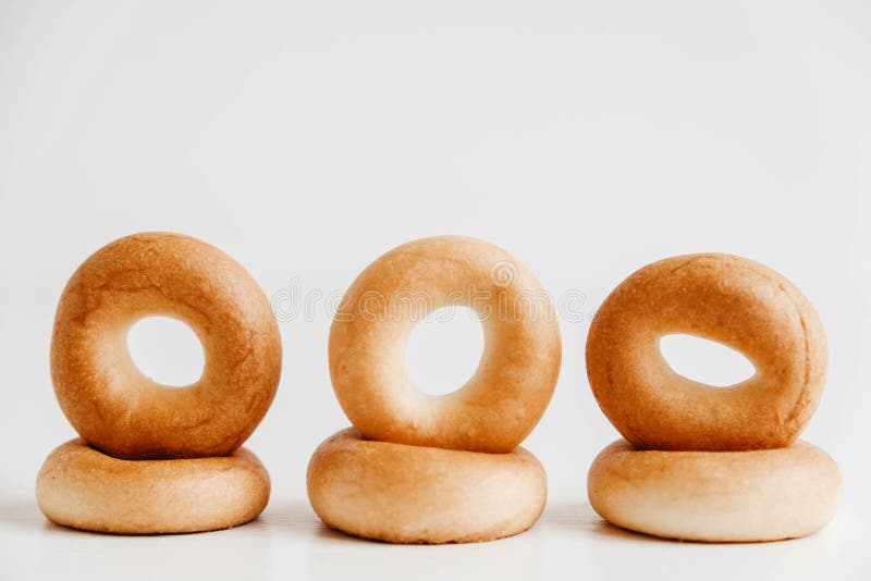 Drying or Mini Round Bagels on a White Wooden Background. Copy, Empty ...