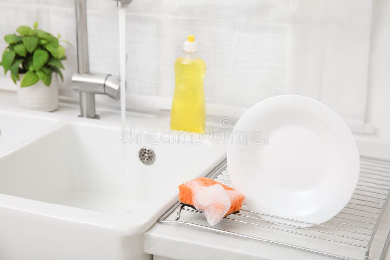 Drying Rack with Clean Plate and Soapy Sponge in Stylish Kitchen Stock ...