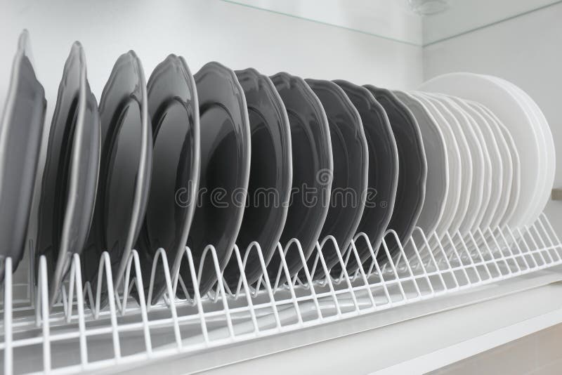 Drying Rack with Clean Plates in Kitchen Cabinet, Closeup Stock Image ...