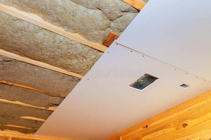 Drywall Installation on Ceiling with Insulation Visible in Residential ...