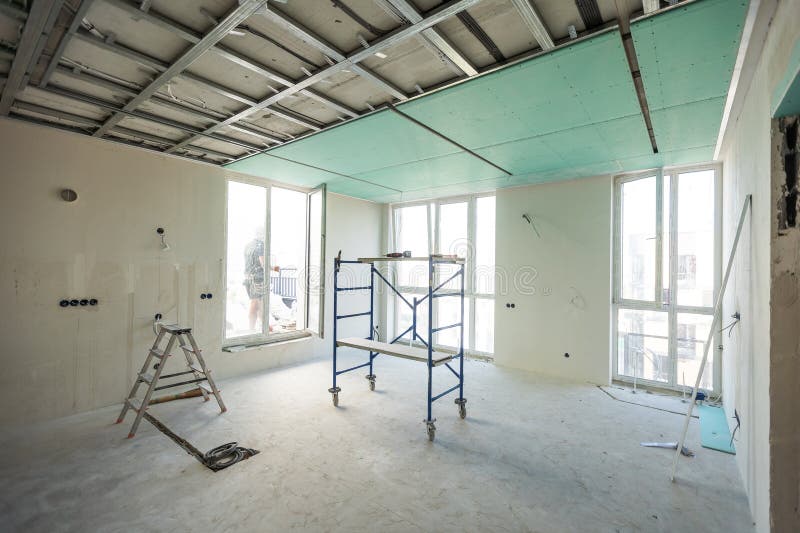 Installation of Drywall. Workers are Using Screws and a Screwdriver To Attach Plasterboard To ...