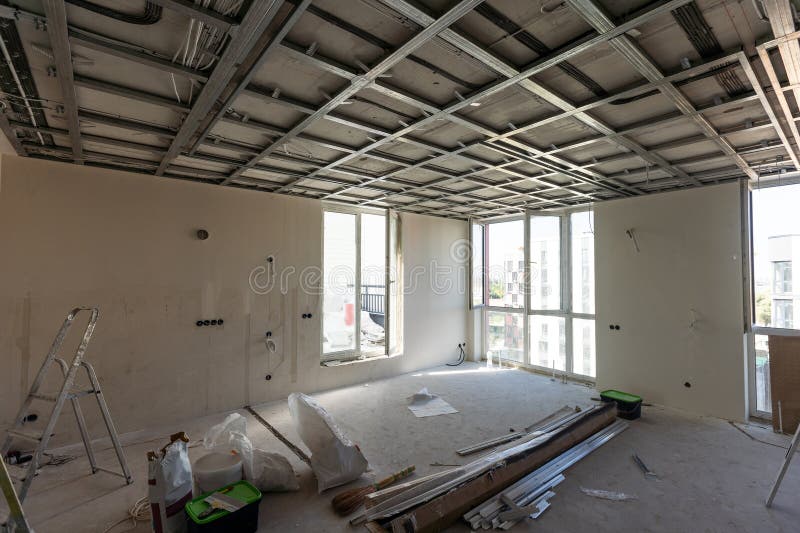 Installation of Drywall. Workers are Using Screws and a Screwdriver To ...