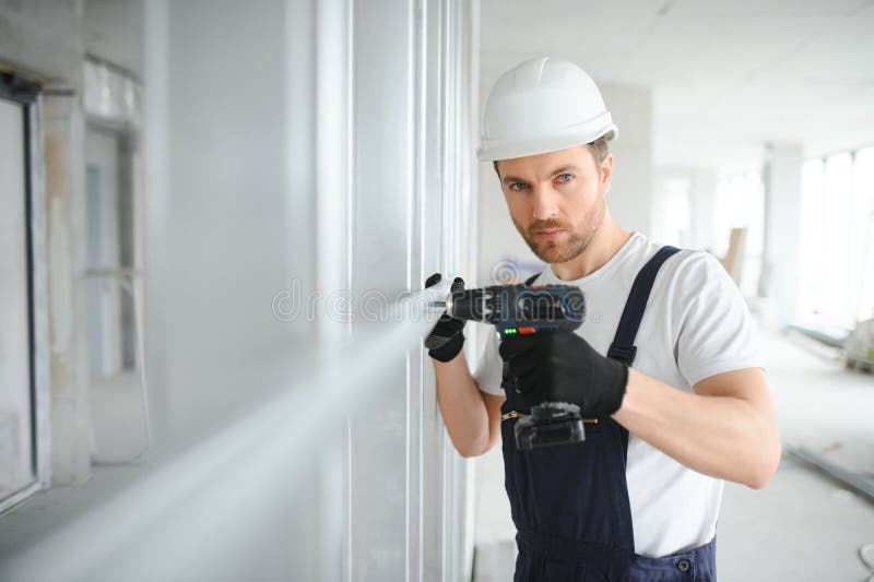 Drywall Worker Works on Building Site in a House. Stock Photo - Image ...