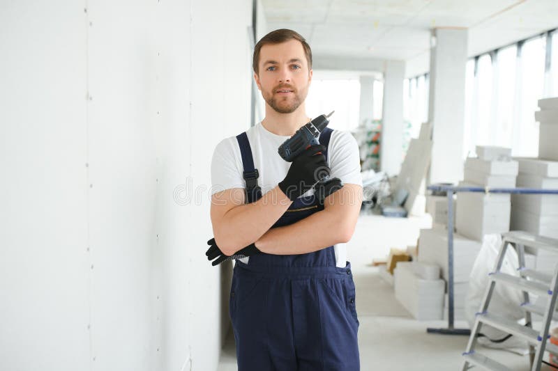 Drywall Worker Works on Building Site in a House. Stock Image - Image ...