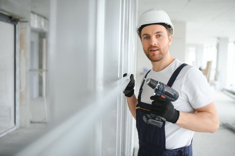 Drywall Worker Works on Building Site in a House. Stock Photo - Image ...