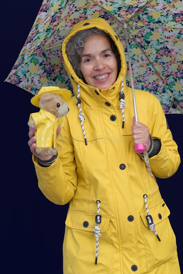 Senior Woman Wearing a Breton Yellow Raincoat. Teddy Bear in Partner ...