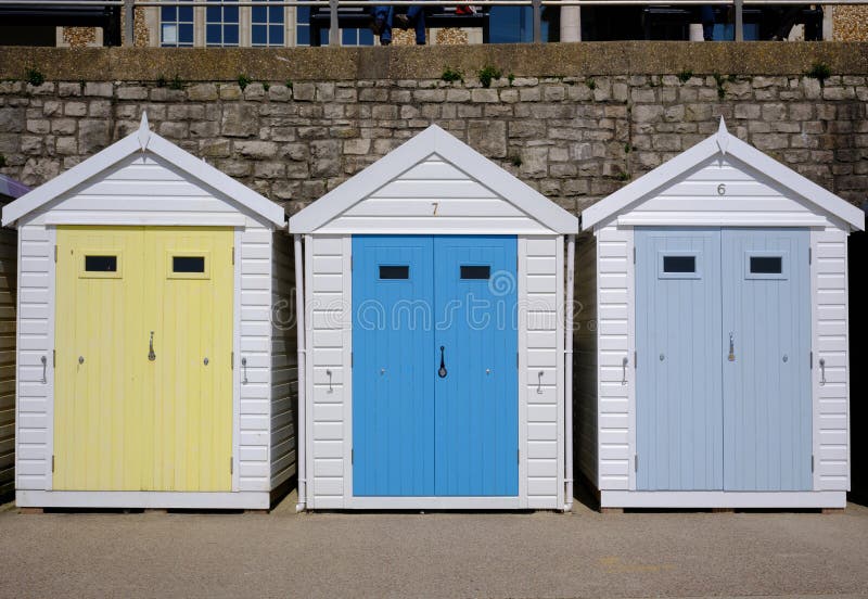 Three Pastel Coloured Beach Huts on the Promenade at Lyme Regis, Dorset ...