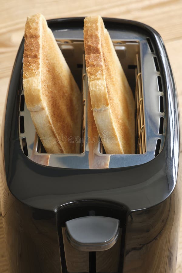 A Black Shiny Toaster with Brown Toasted Bread Stock Photo - Image of ...