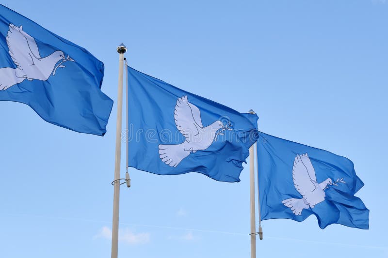 Three Blue Peace Flags with a Dove and Olive Branch in Its Beak ...